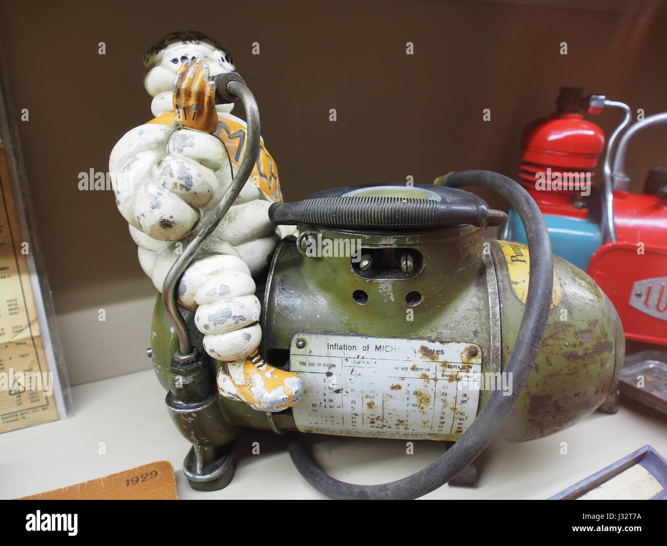 The image depicts an early 20th-century Michelin air pump, a key tool ...