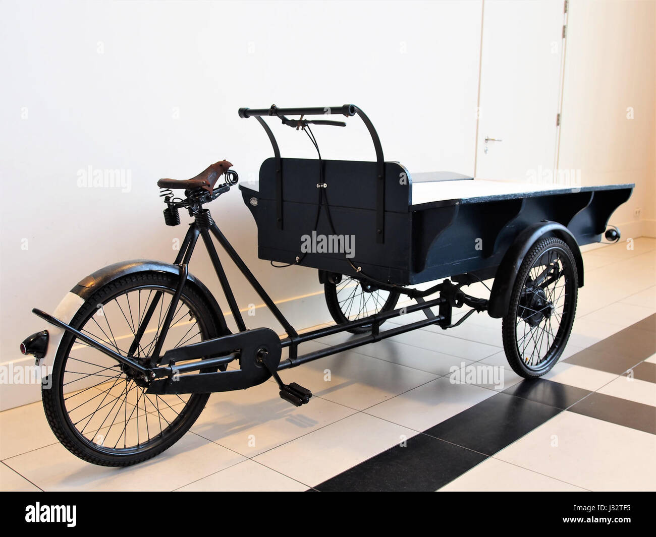 The photo shows a traditional 'bakfiets,' a cargo bicycle, from the ...