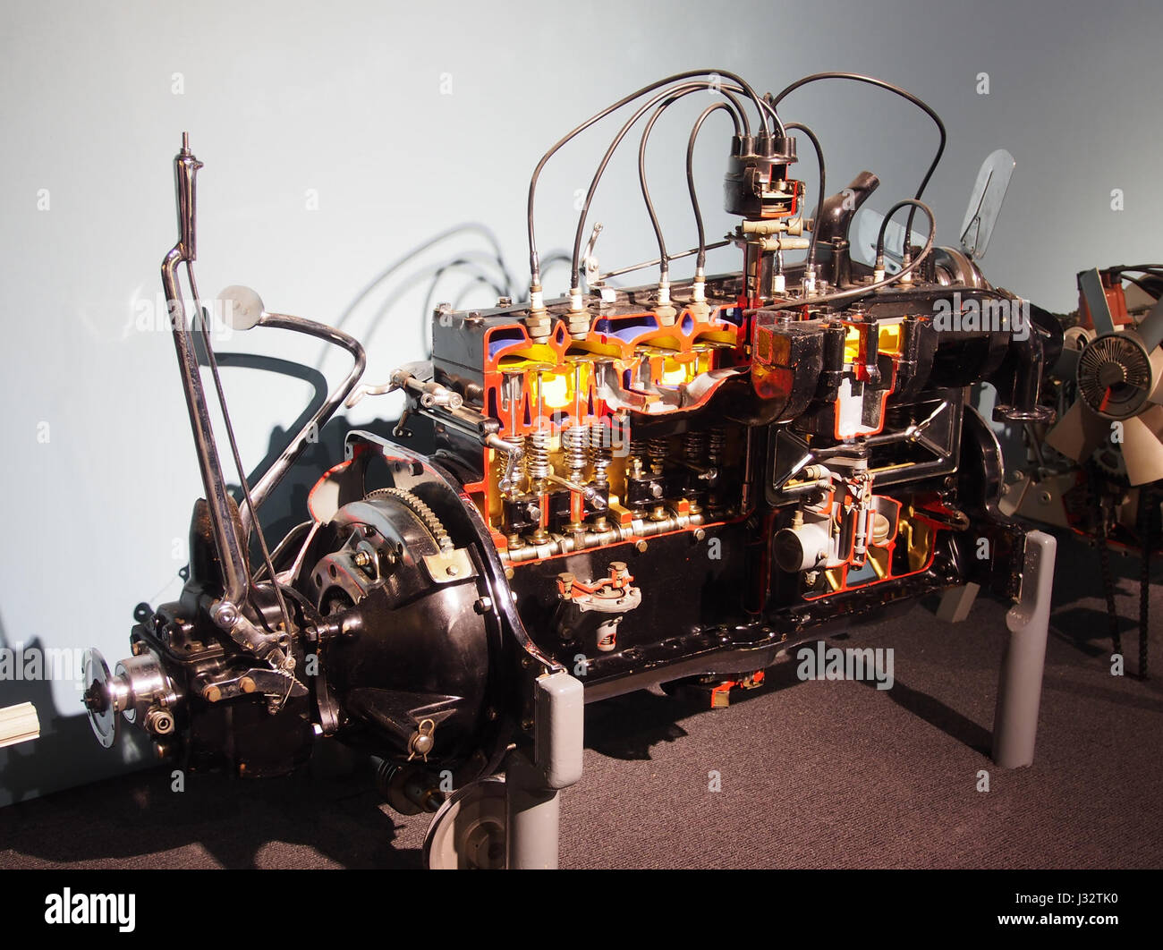 This image features a close-up of a car engine displayed at the Louwman ...