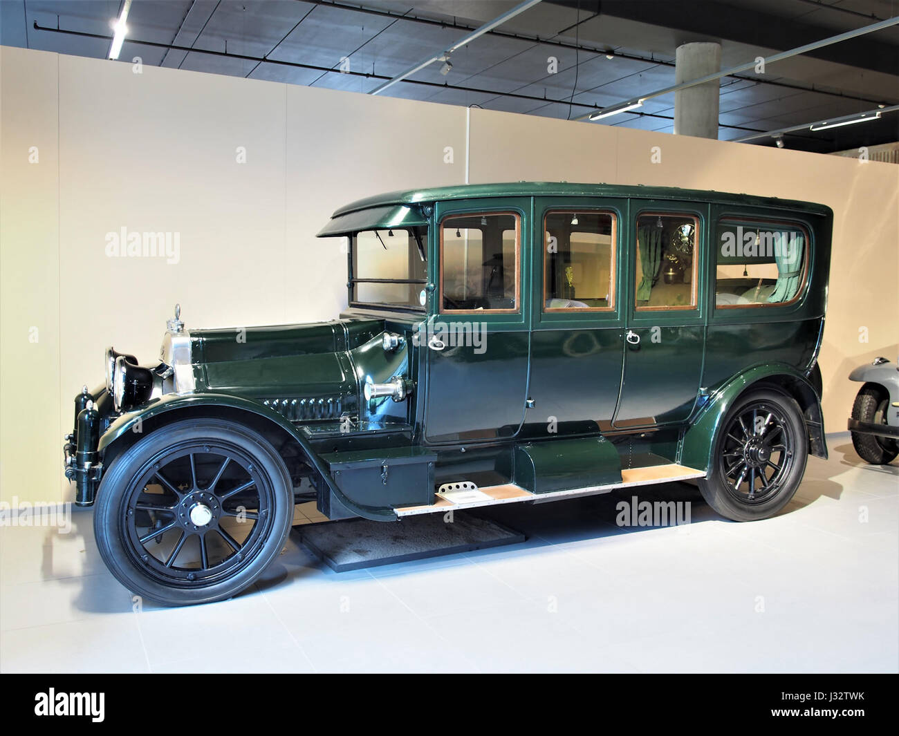 The image features a 1915 Cadillac Model 51 V8, an early 20th-century ...