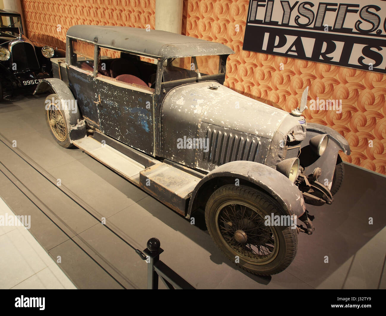 The image features a 1925 Voisin C7 Demi-Berline, a vintage two-door ...