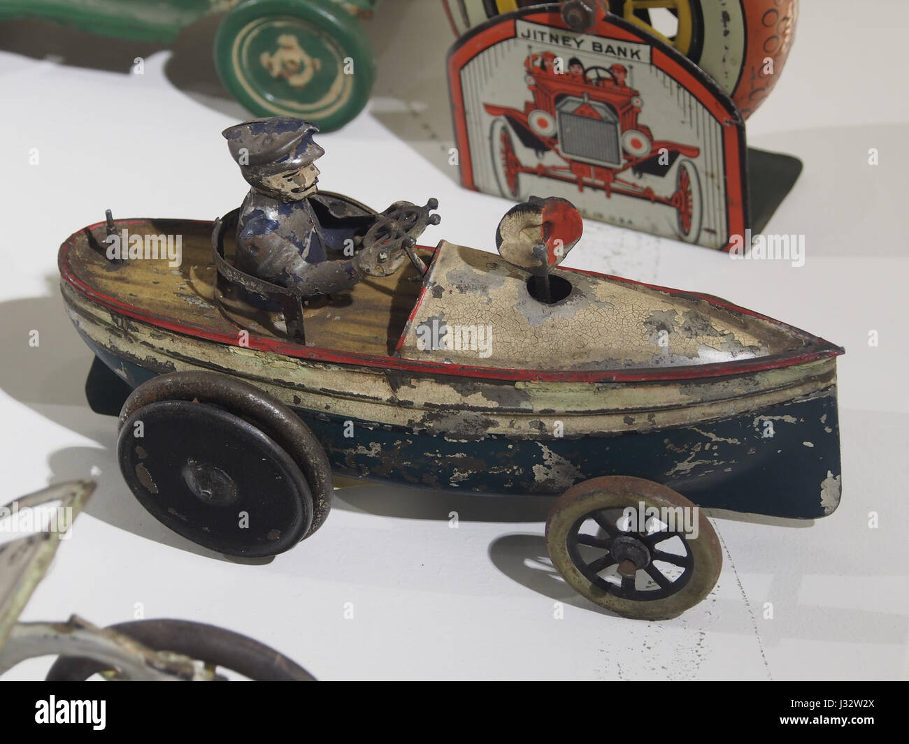 A photograph of a tin toy car displayed at the Louwman Museum. The toy ...