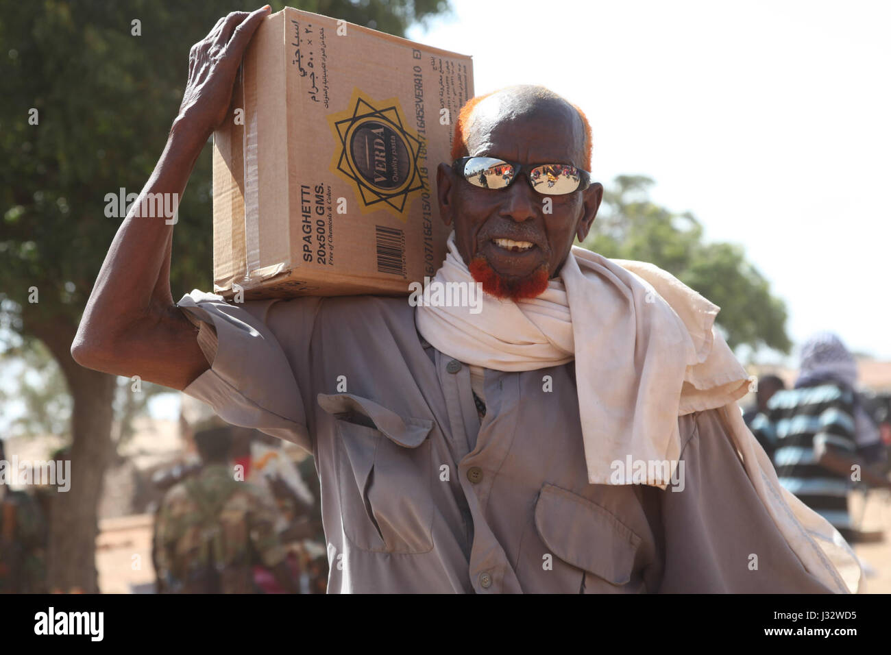 On January 15, 2017, residents of Goobweyn, Somalia, receive food aid ...