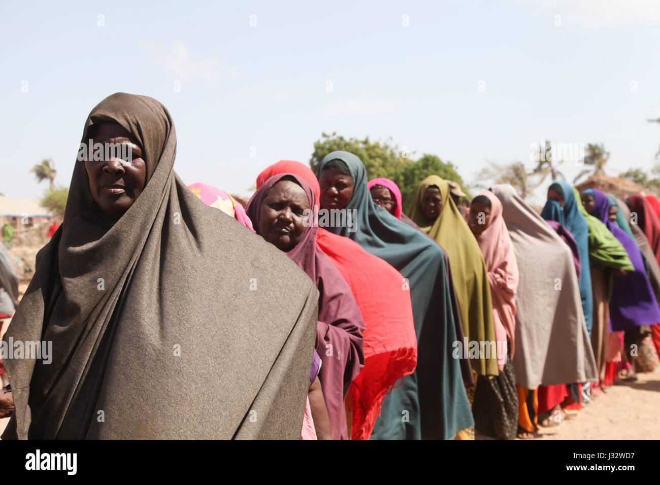 Residents of Goobweyn, Somalia, receive food aid from the Ethiopian ...