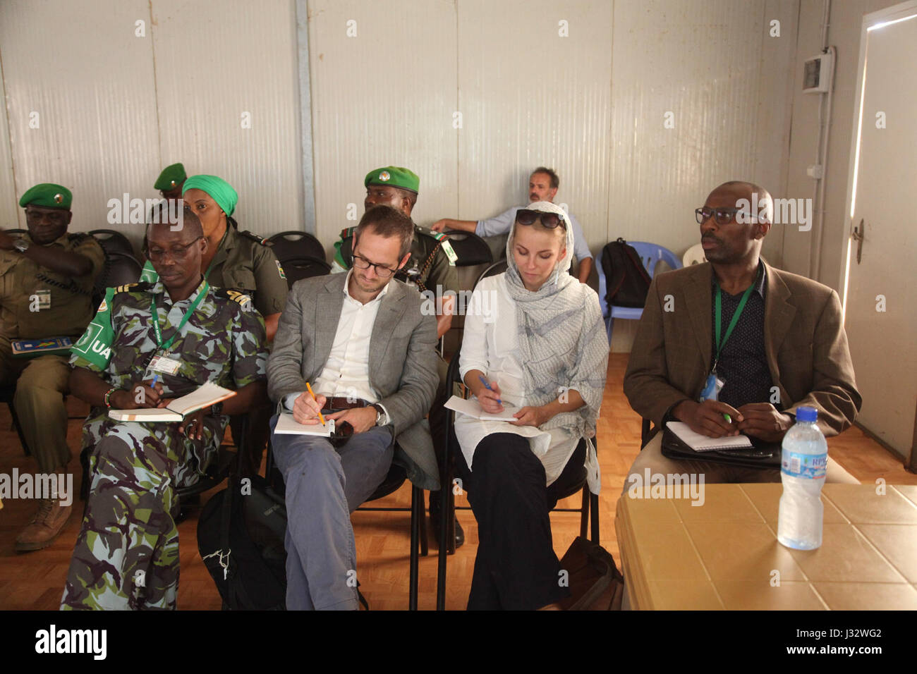 Officers from the African Union Mission in Somalia (AMISOM), attend a ...