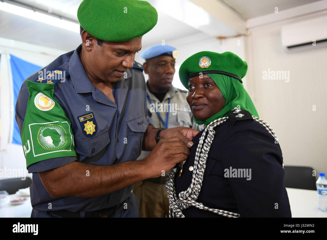 This image shows AMISOM Police Commissioner Anand Pillay awarding a ...