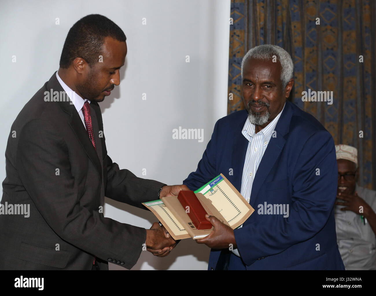 The image shows a formal ceremony where Somalia’s Ambassador to Kenya ...