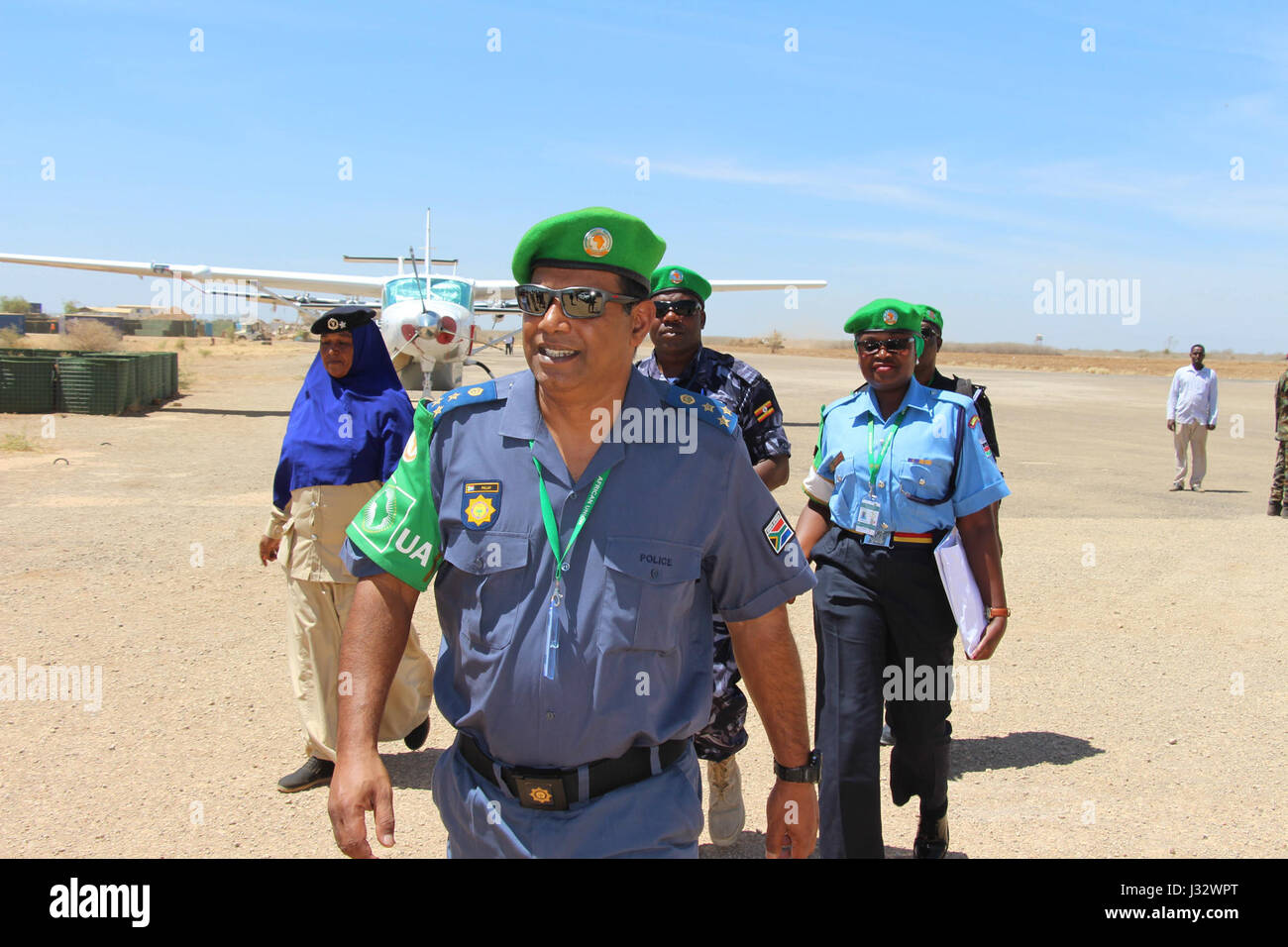 This image depicts AMISOM Police Commissioner Anand Pillay and other ...