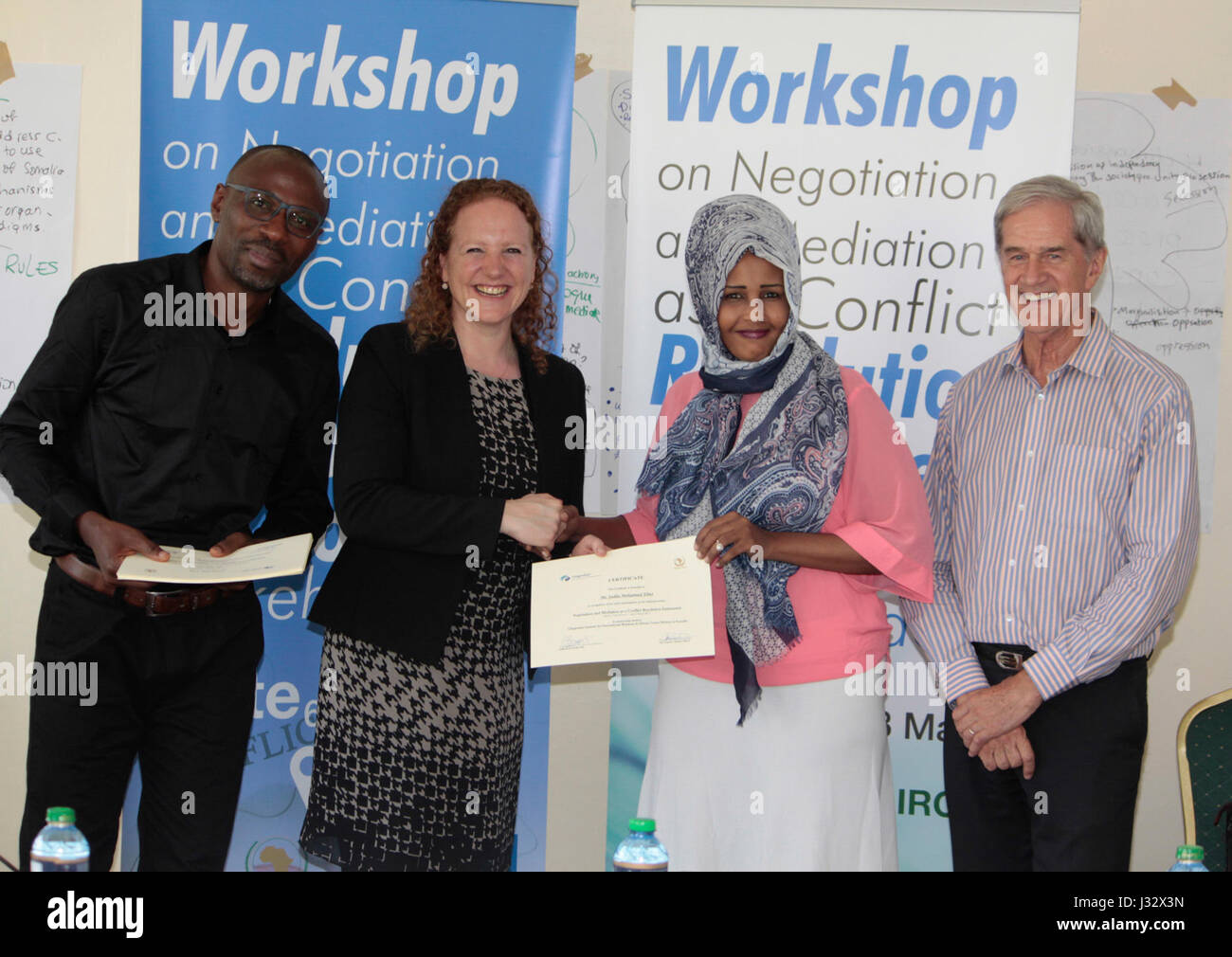 Sadia Mohamed Elmi (2nd right) receives a certificate from Judith van ...