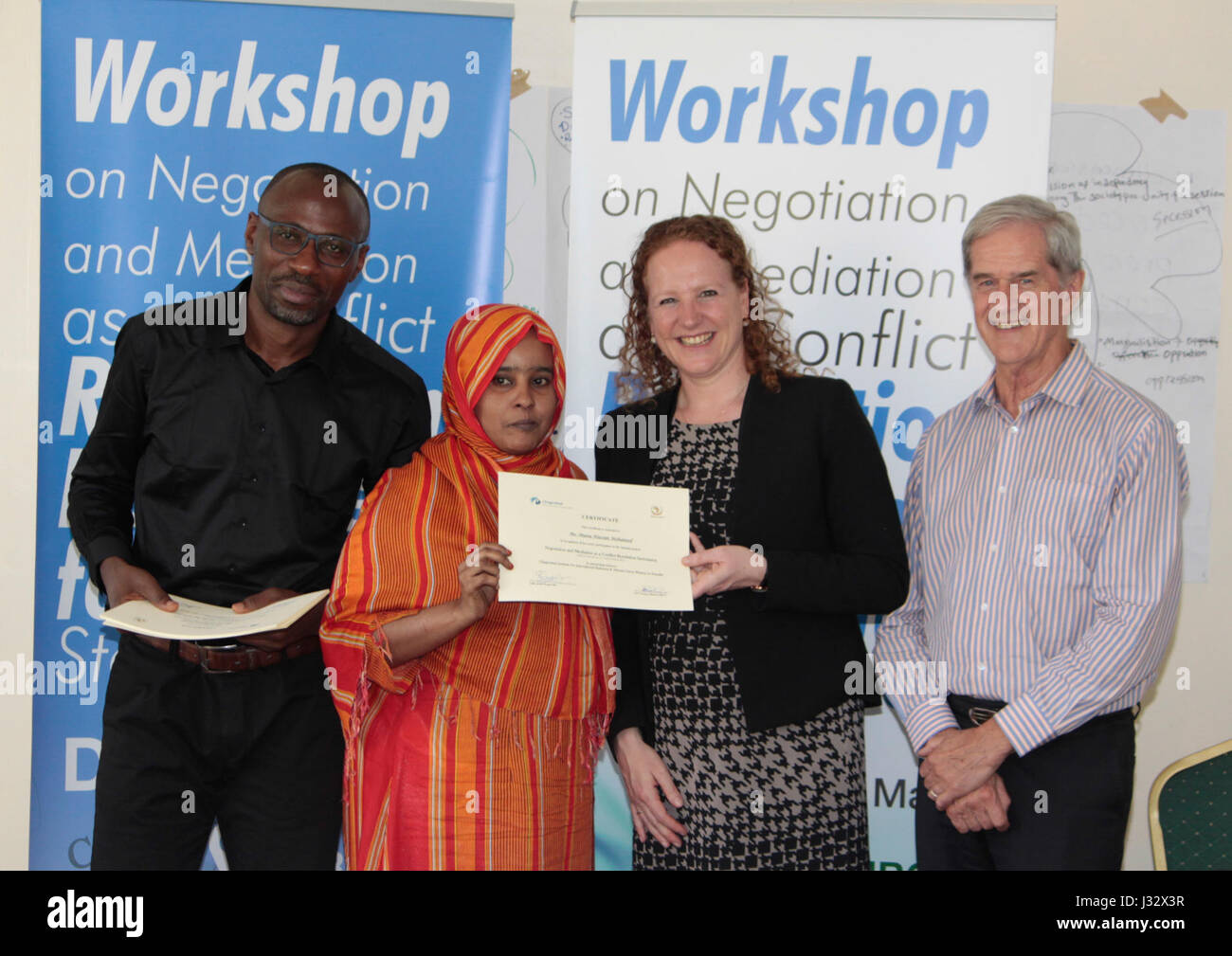 Ms. Muna Hassan Mohamed receives a certificate from Judith van den ...