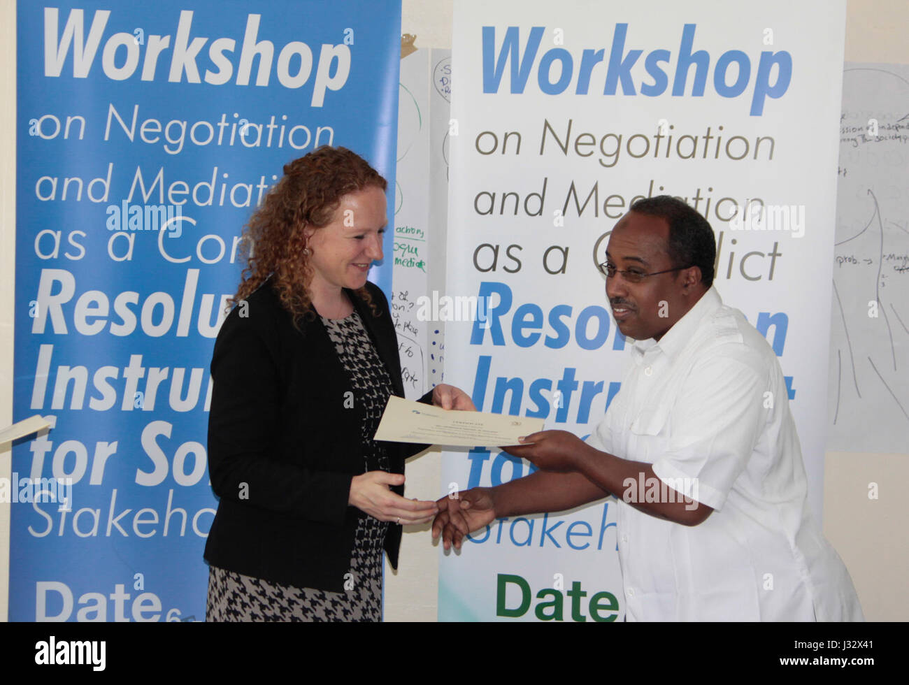 This image captures Mohamed Hassan Daryeel receiving a certificate ...