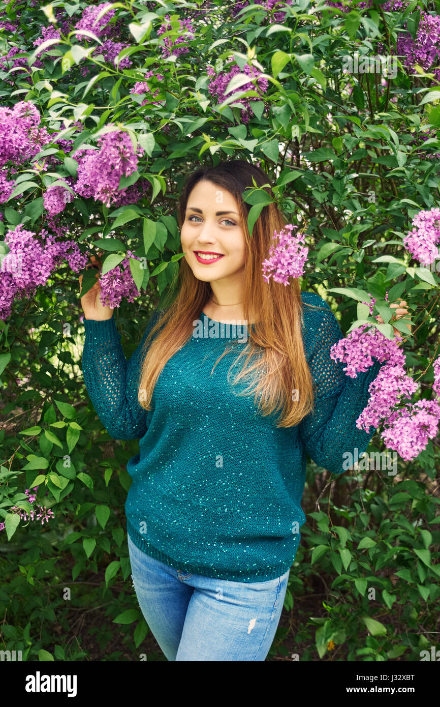 A female portrait with spring blossoming lilac Stock Photo - Alamy