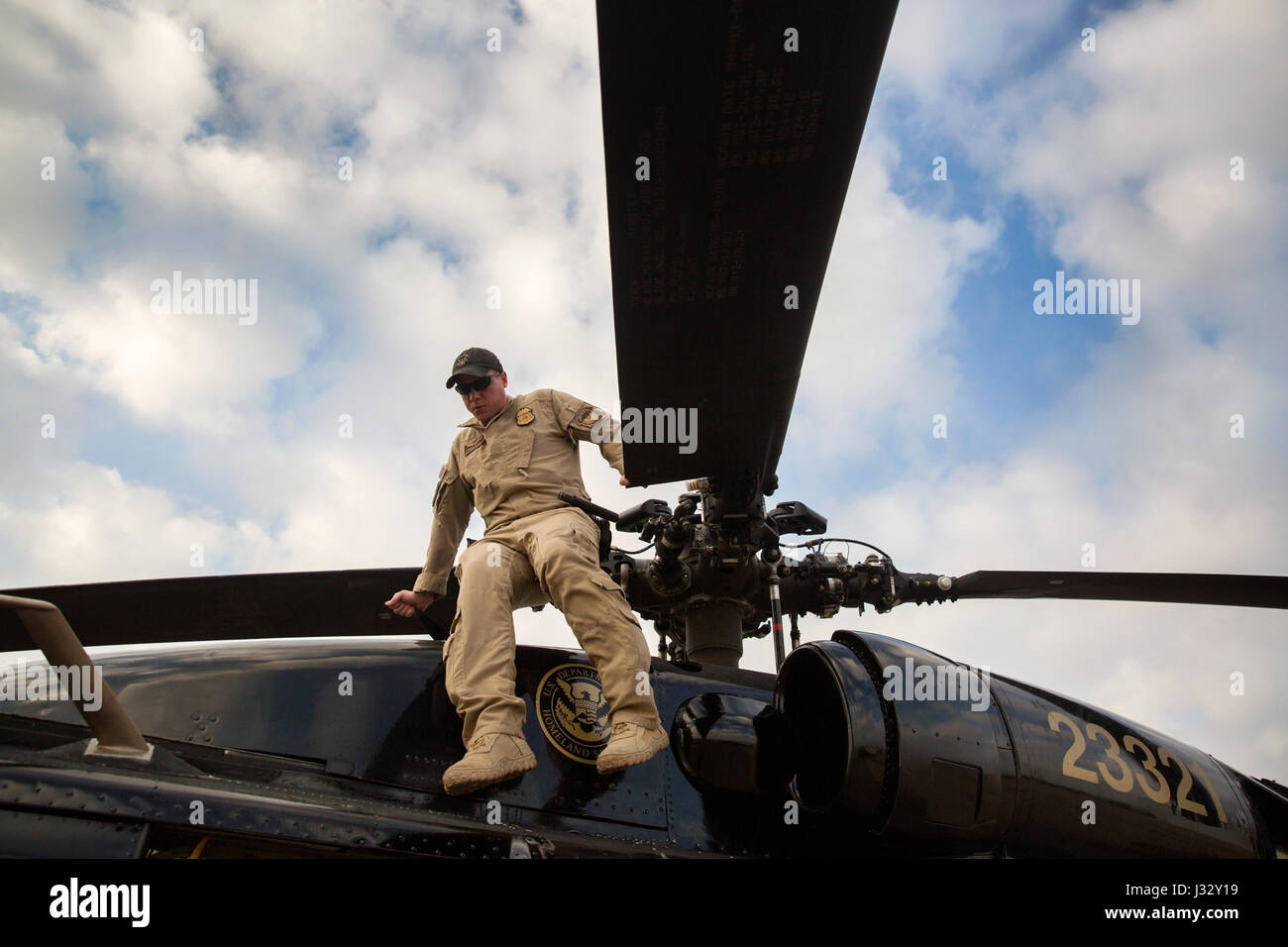 A U.S. Customs and Border Protection agent conducts a pre-flight check ...