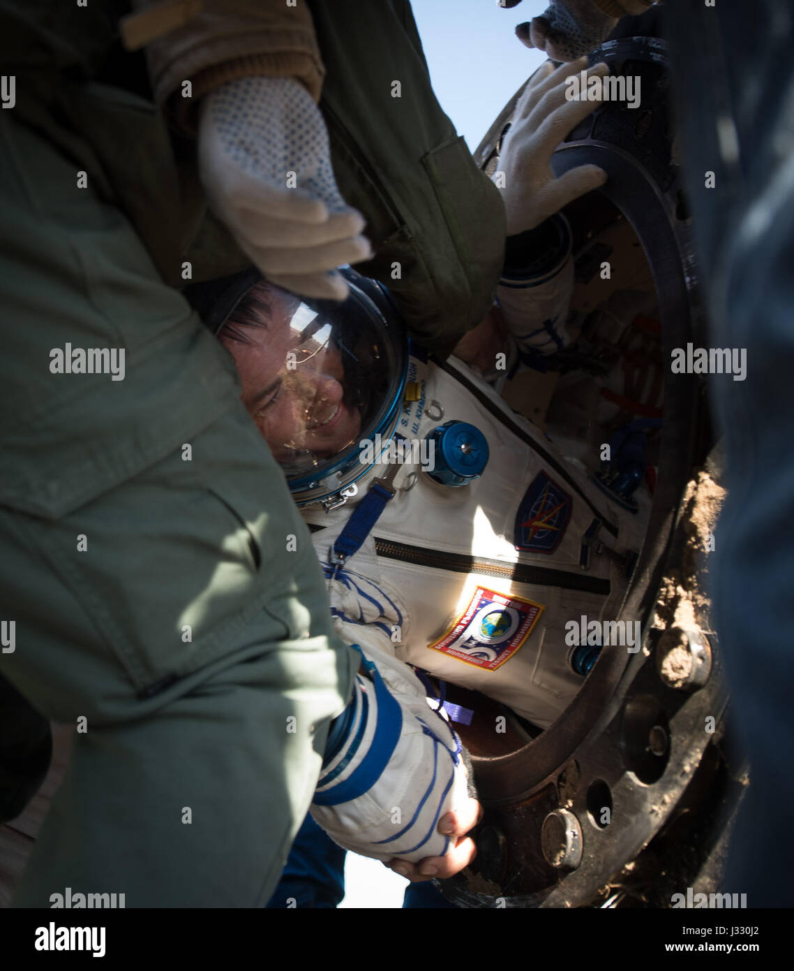 NASA astronaut Shane Kimbrough is helped out of the Soyuz MS-02 ...