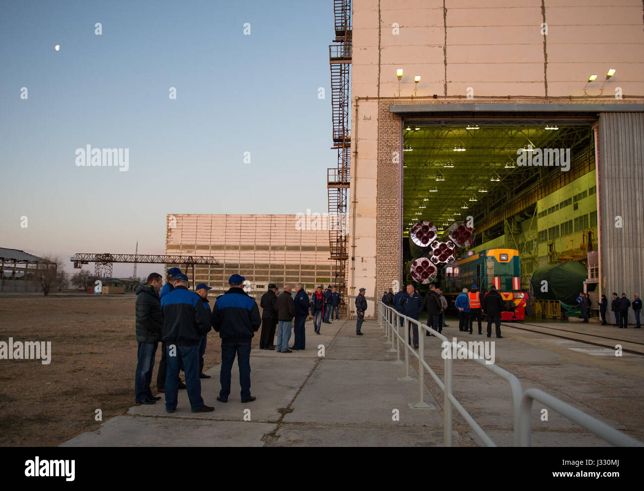 The image shows the Soyuz rocket being prepared for launch at Baikonur ...