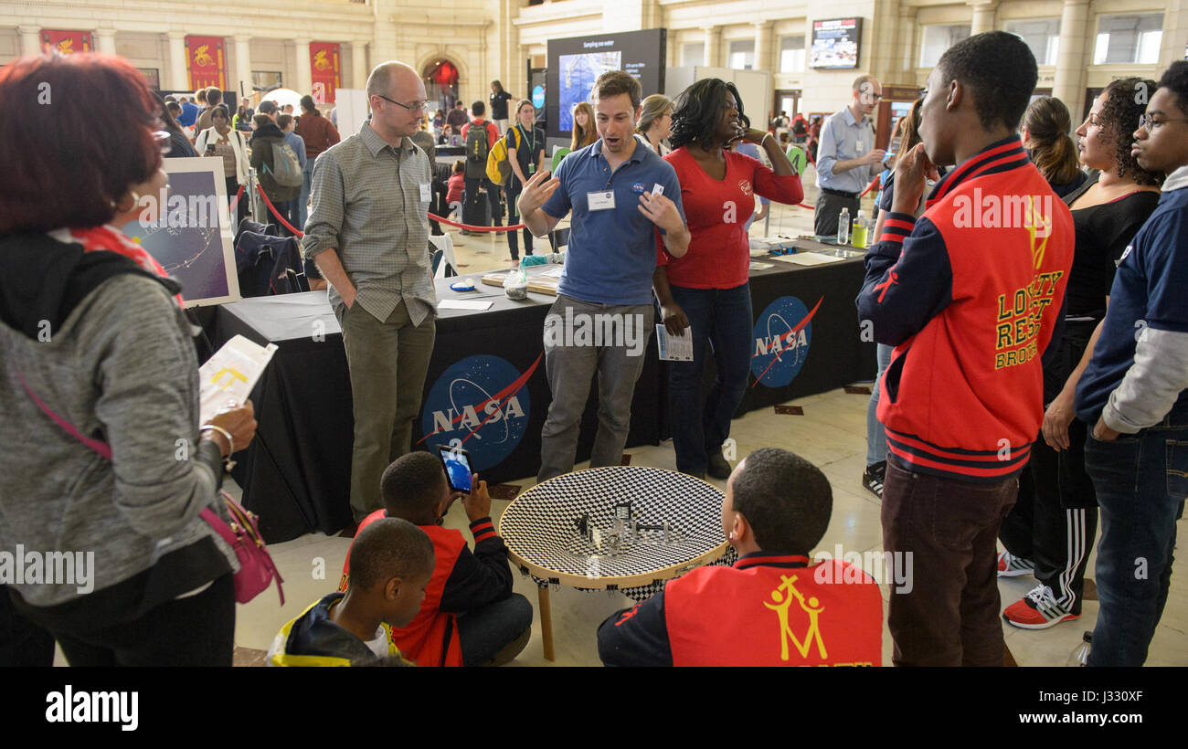 Visitors engaged with NASA's exhibit during the Earth Day event at ...