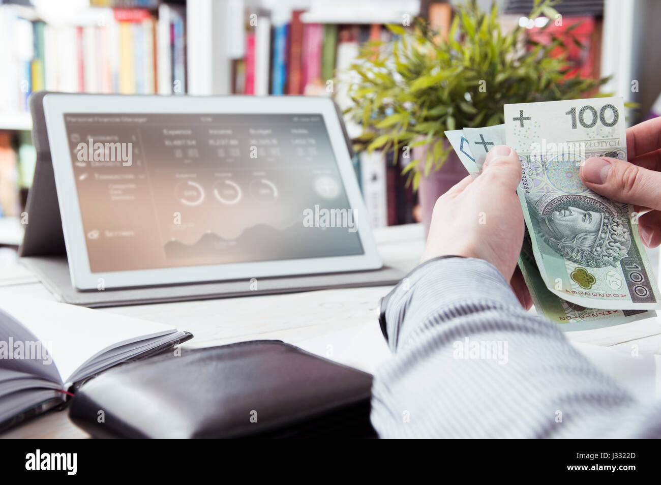 Man holds money. Personal finance manager application in background ...