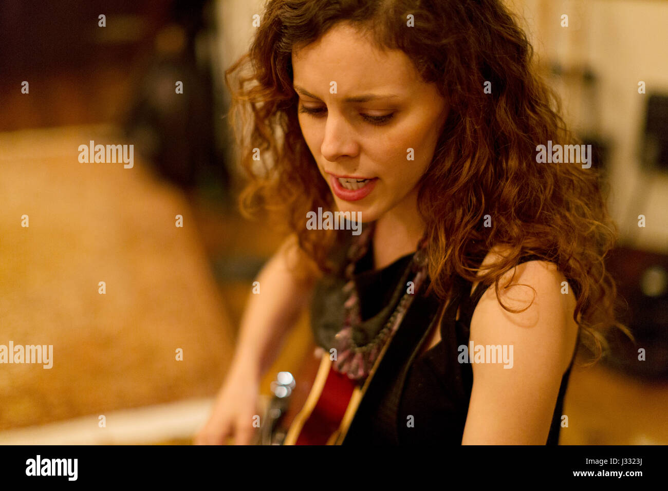 Female singer playing guitar recording hi-res stock photography and ...