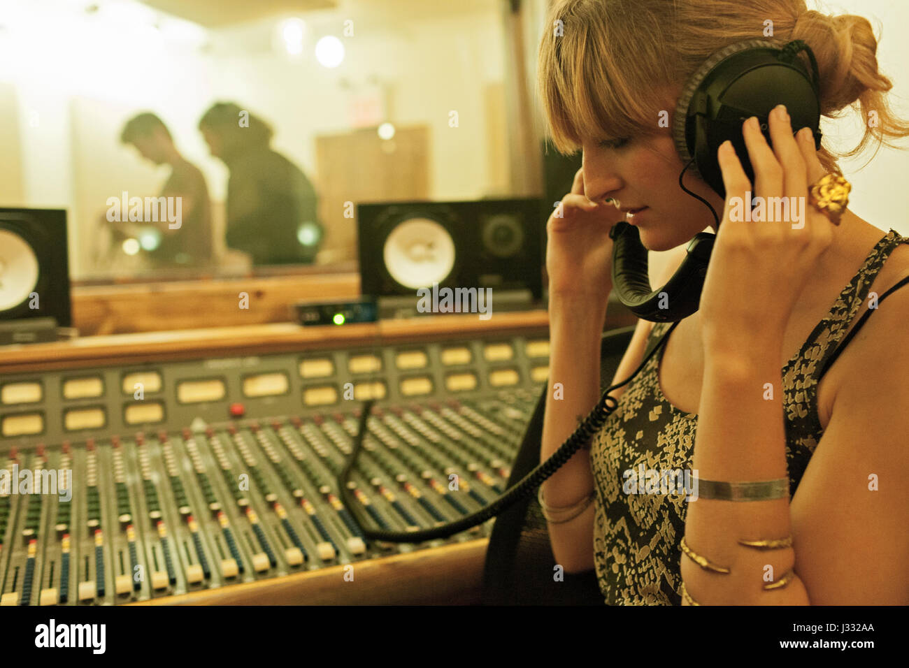 Portrait of a young woman in a recording studio Stock Photo - Alamy