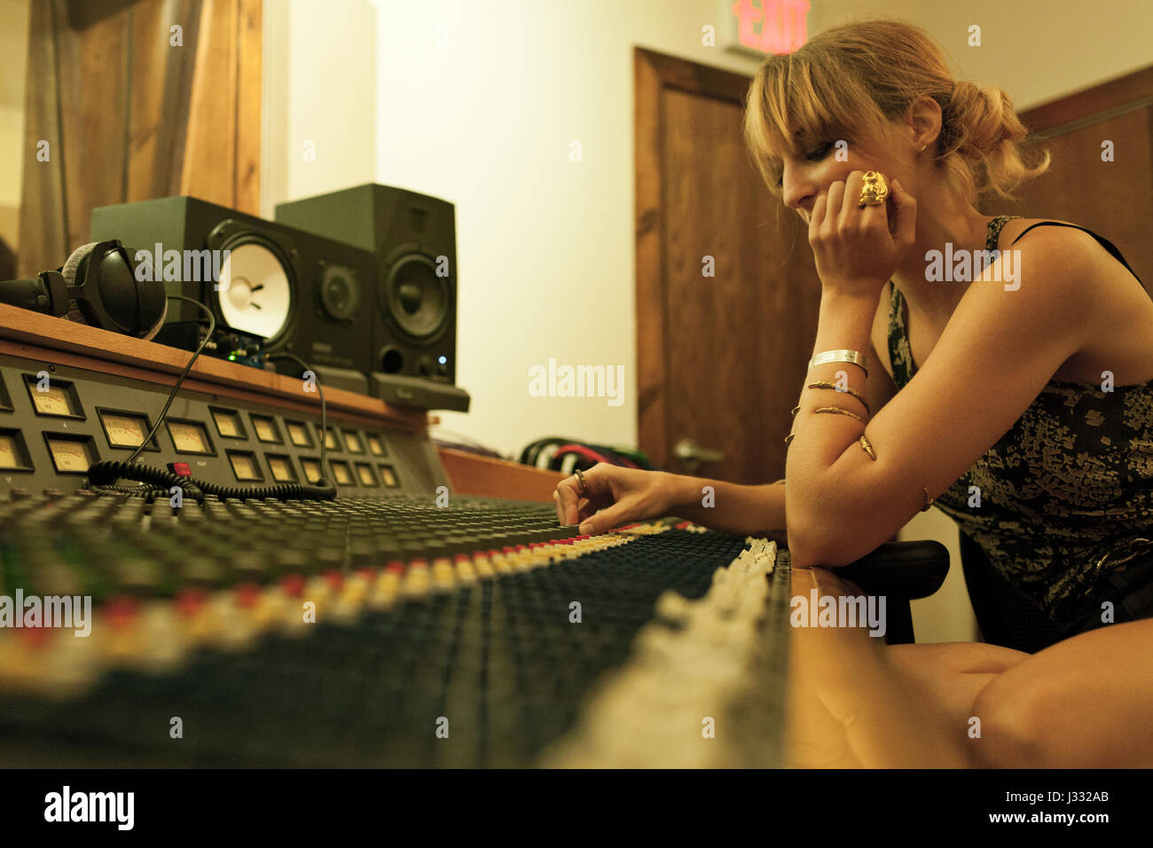 Portrait of a young woman in a recording studio Stock Photo - Alamy