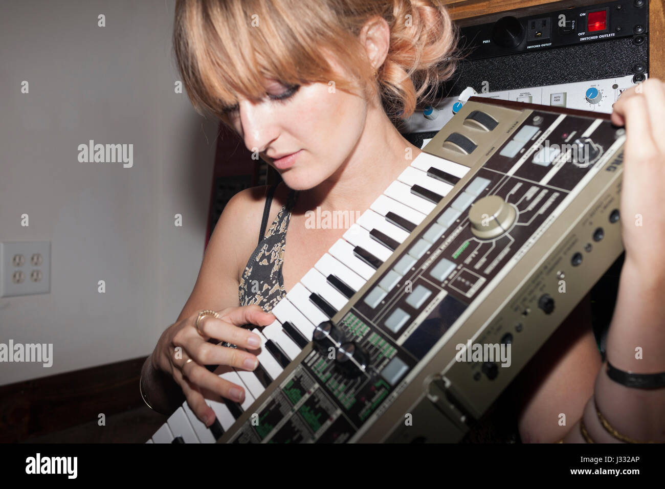 Young female musician playing a keyboard Stock Photo - Alamy