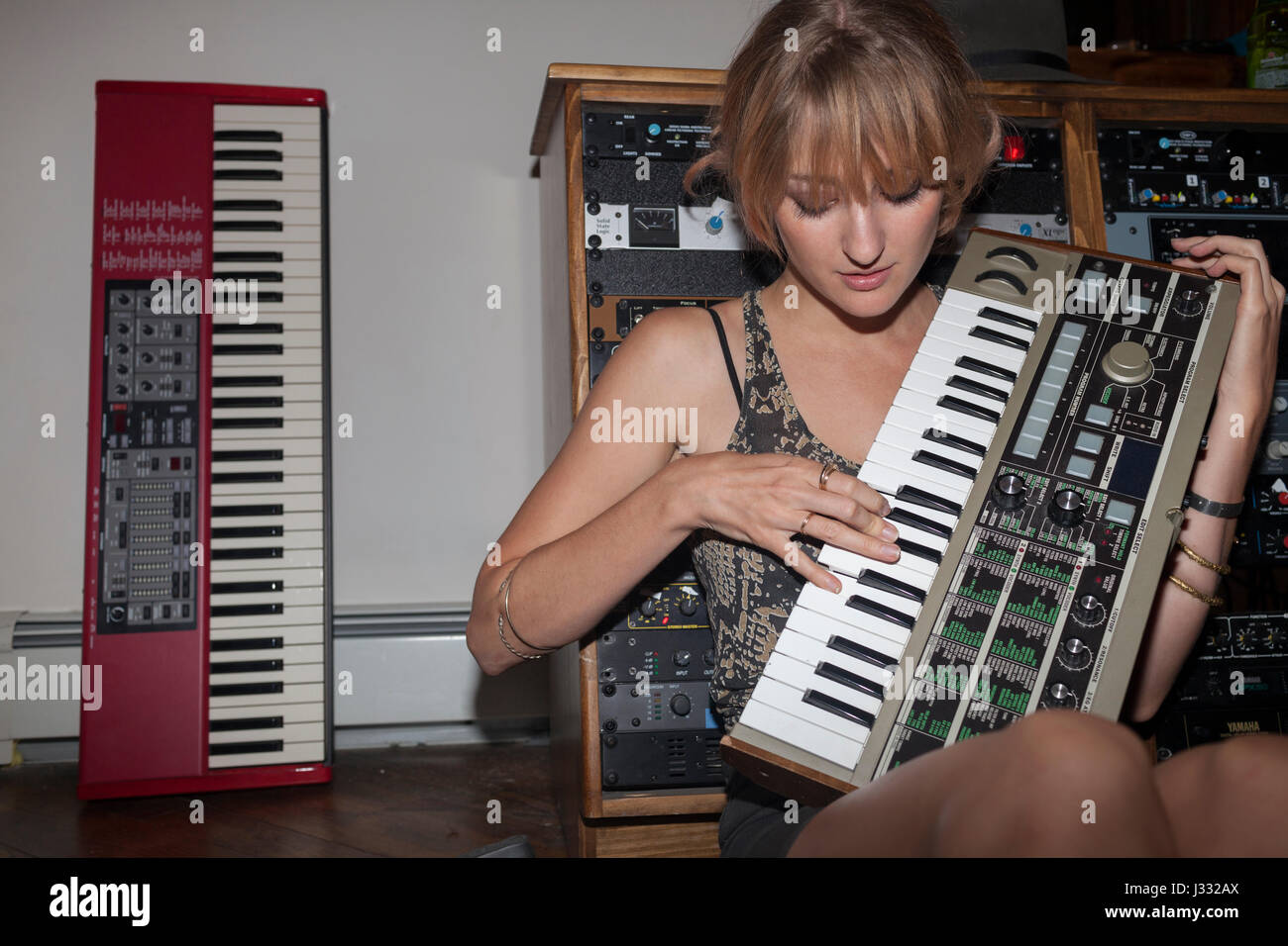 Young female musician playing a keyboard Stock Photo - Alamy