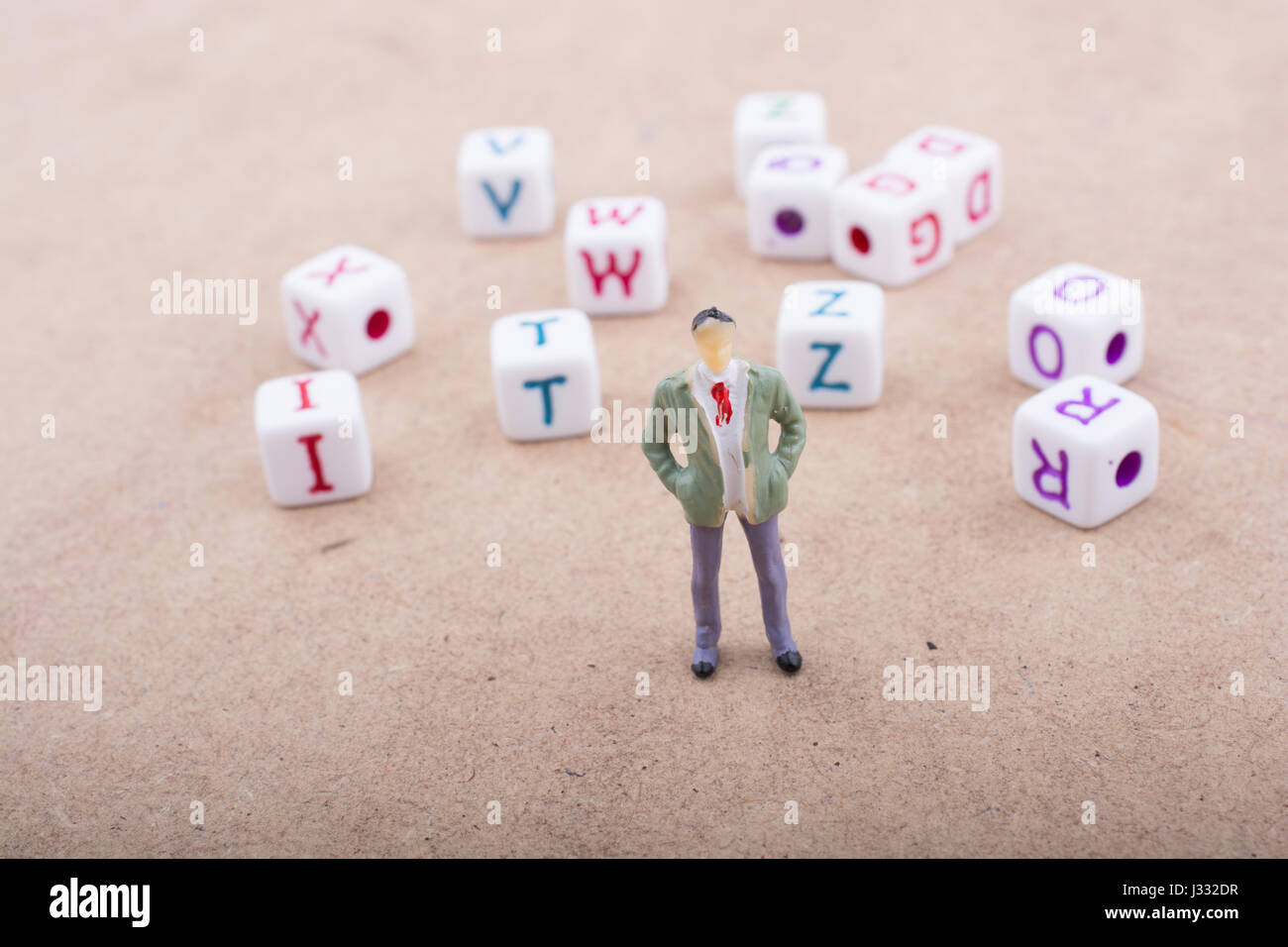 Figurine standing in front of the colorful alphabet letter cubes Stock ...