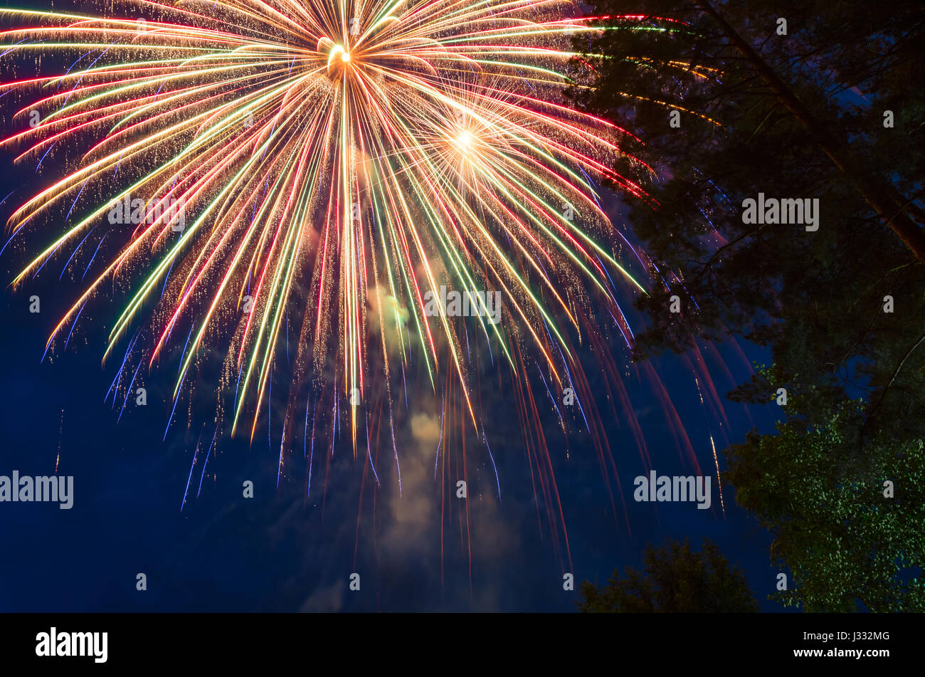 Beautiful background with fireworks on a blue sky, and the silhouettes ...