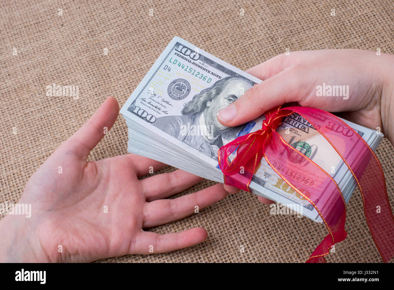 Banknote bundle of US dollar tied with colorful a ribbon Stock Photo ...