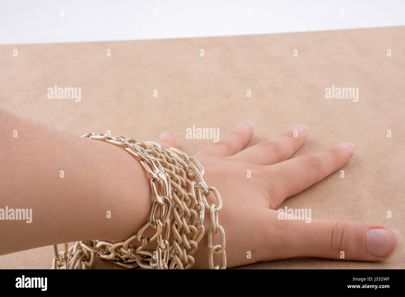 Gold color chain around the wrist of a child Stock Photo - Alamy
