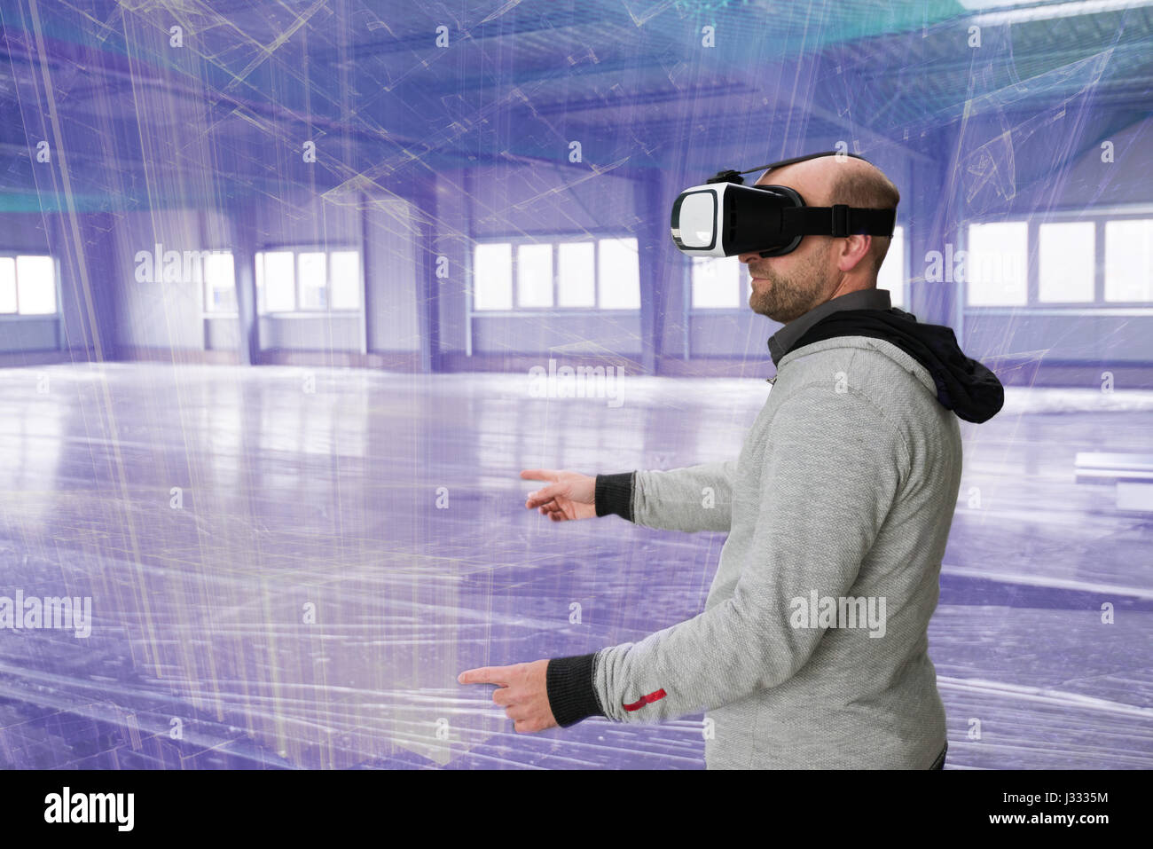 Architect with VR visor exploring industrial building environment with ...
