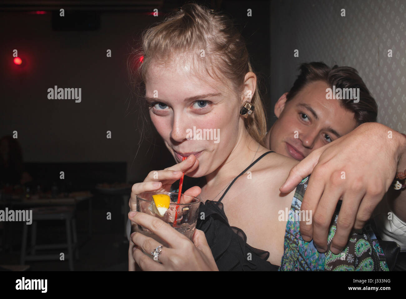 Friends hanging out at a nightclub Stock Photo - Alamy