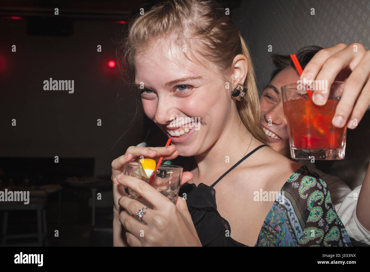 Friends hanging out at a nightclub Stock Photo - Alamy