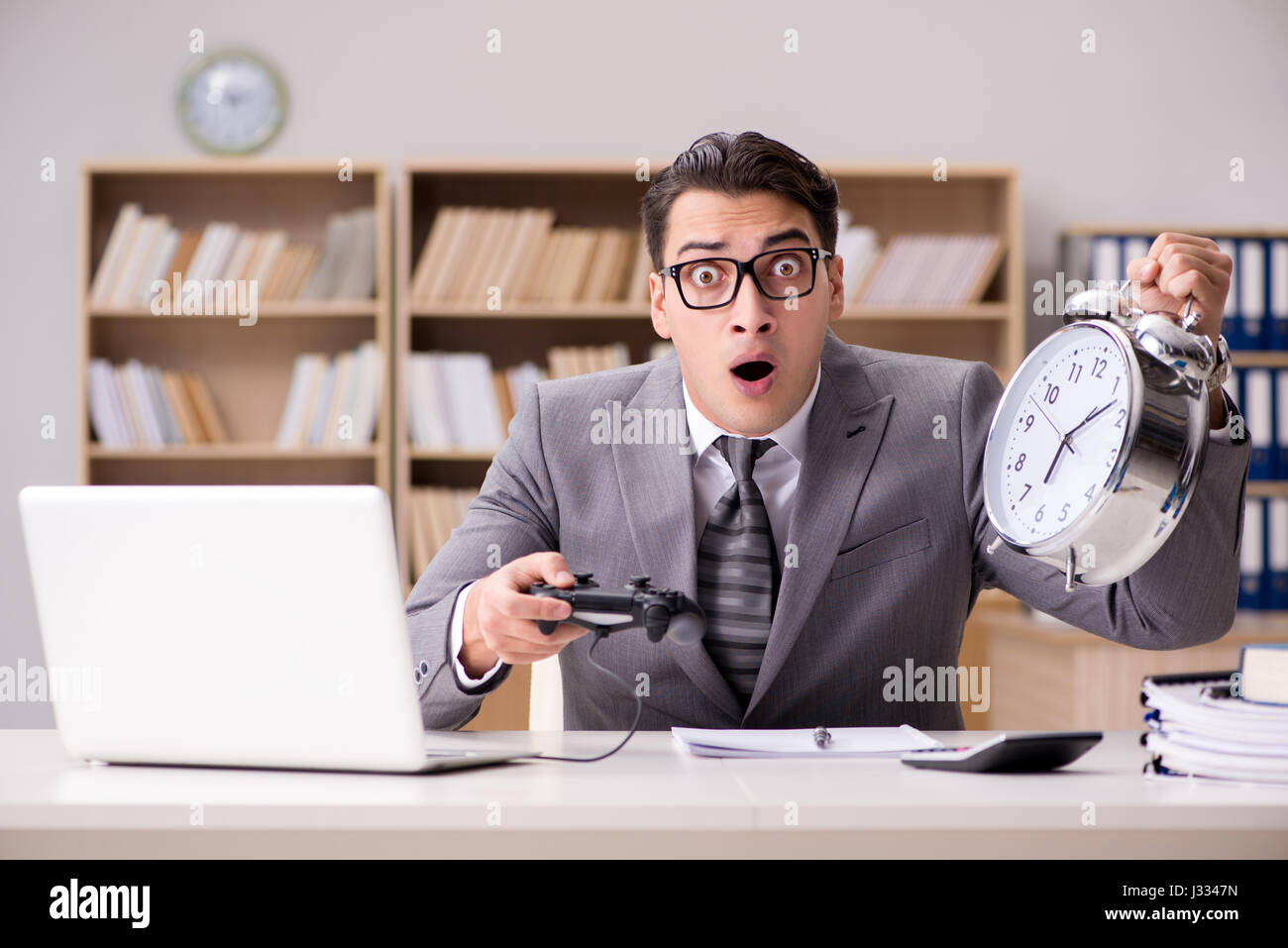 Businessman playing computer games at work office Stock Photo - Alamy