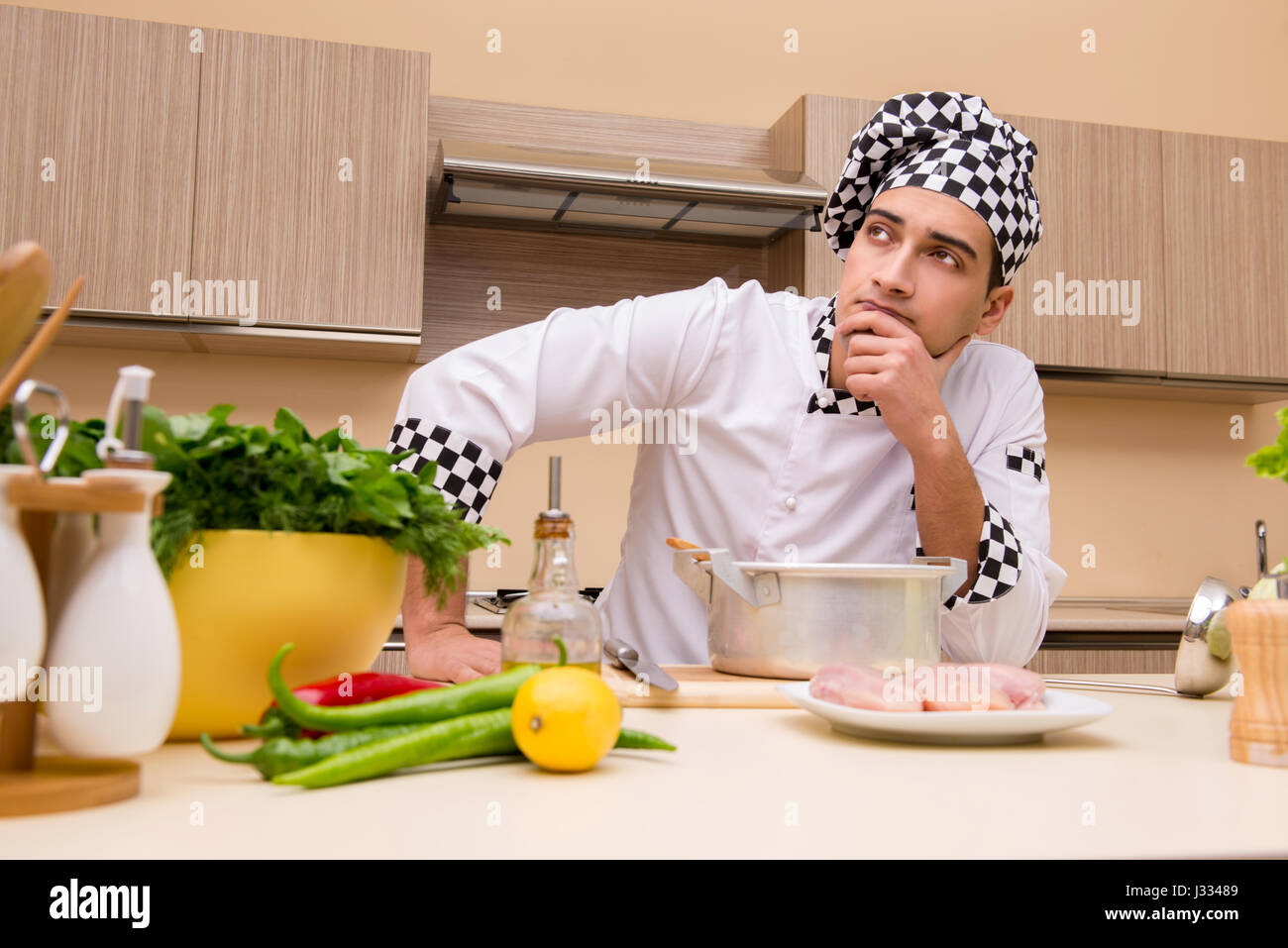 Young chef working in the kitchen Stock Photo - Alamy