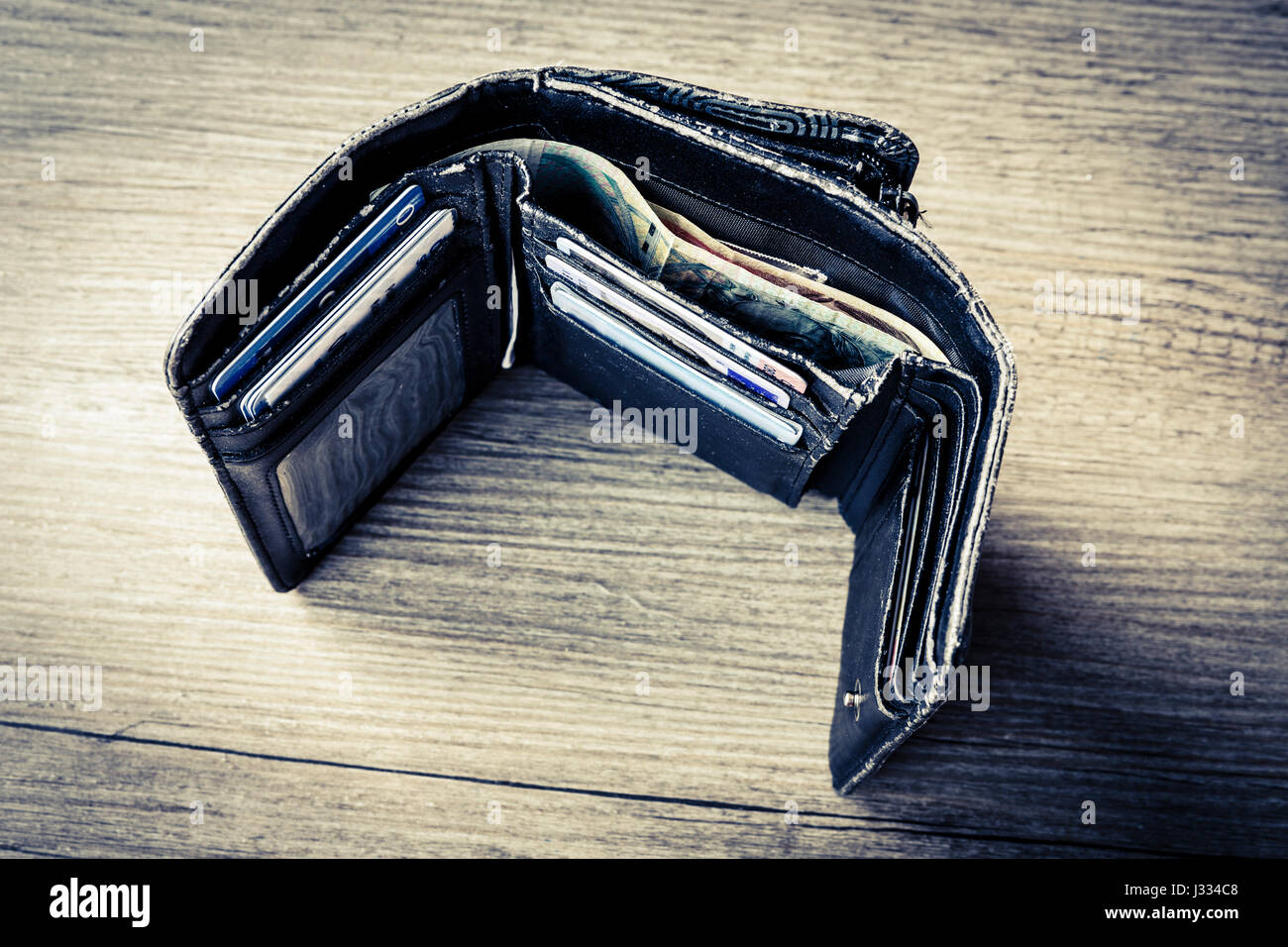 open black woman wallet with money and id cards on the wooden table ...