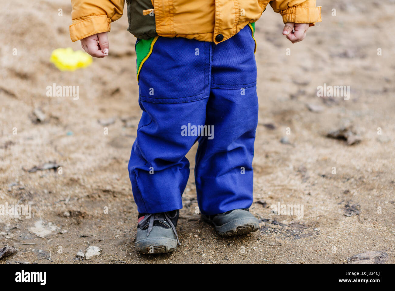 detail of child legs in overalls - boy in blue workwear Stock Photo - Alamy