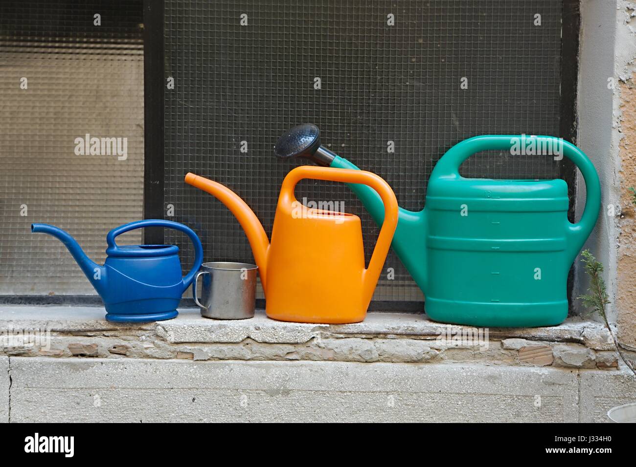 Three watering cans Stock Photo - Alamy