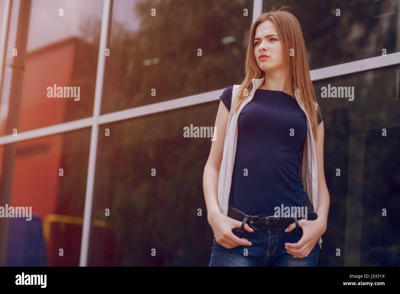 stylish young model walk in the street and pose for a photo on a Sunny ...