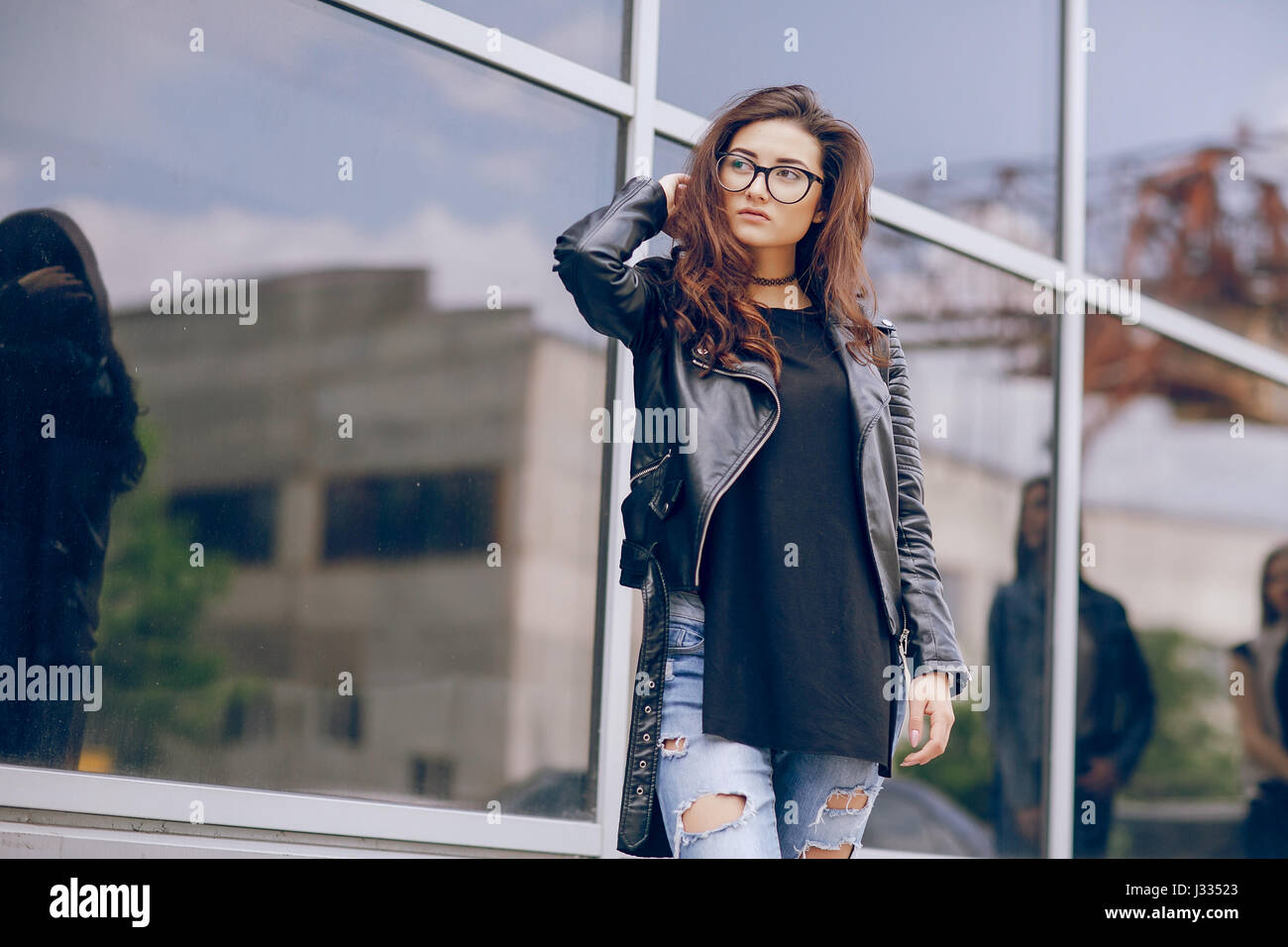 stylish young model walk in the street and pose for a photo on a Sunny ...