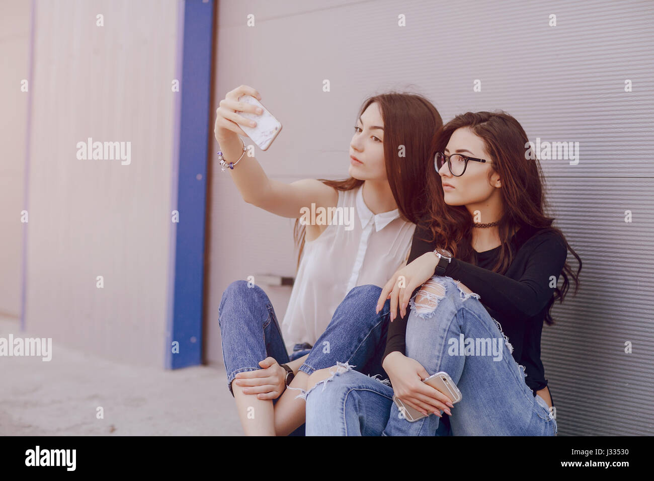 stylish young model walk in the street and pose for a photo on a Sunny ...