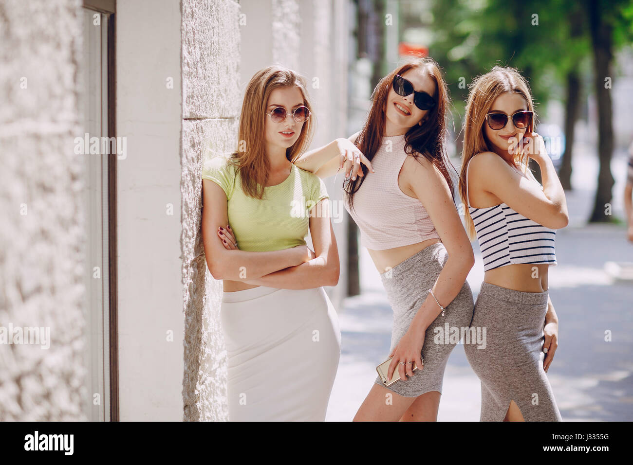 three beautiful girls walking around the city Stock Photo - Alamy