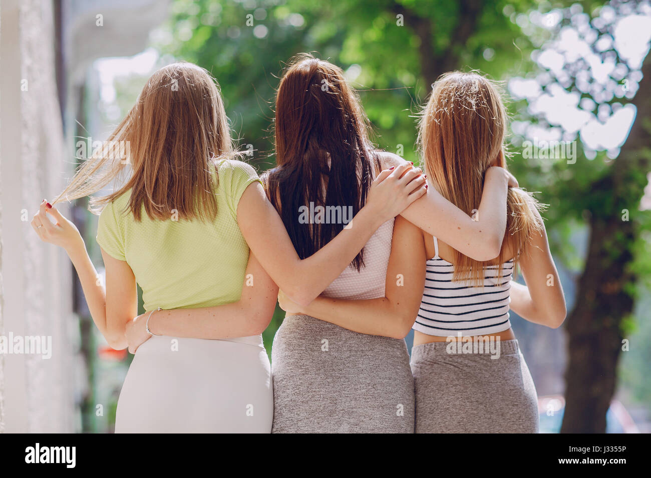 three beautiful girls walking around the city Stock Photo - Alamy