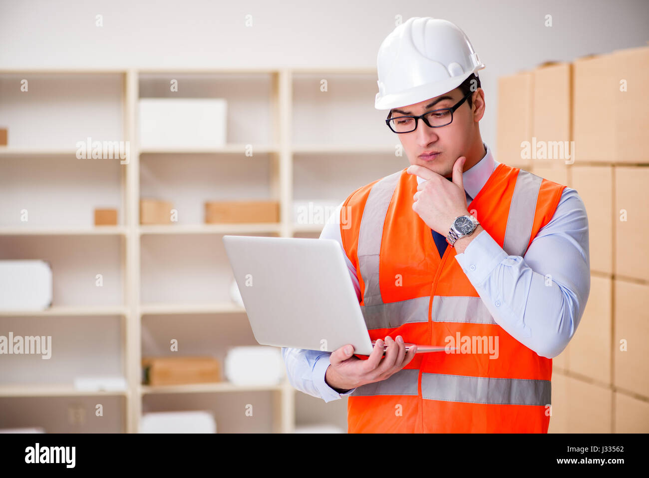 Man working in postal parcel delivery service office Stock Photo - Alamy