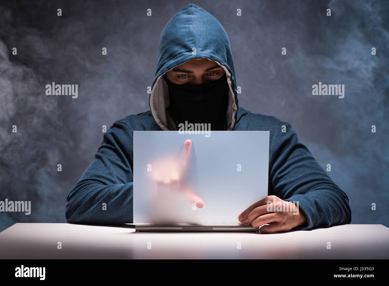 Computer hacker working in dark room Stock Photo - Alamy