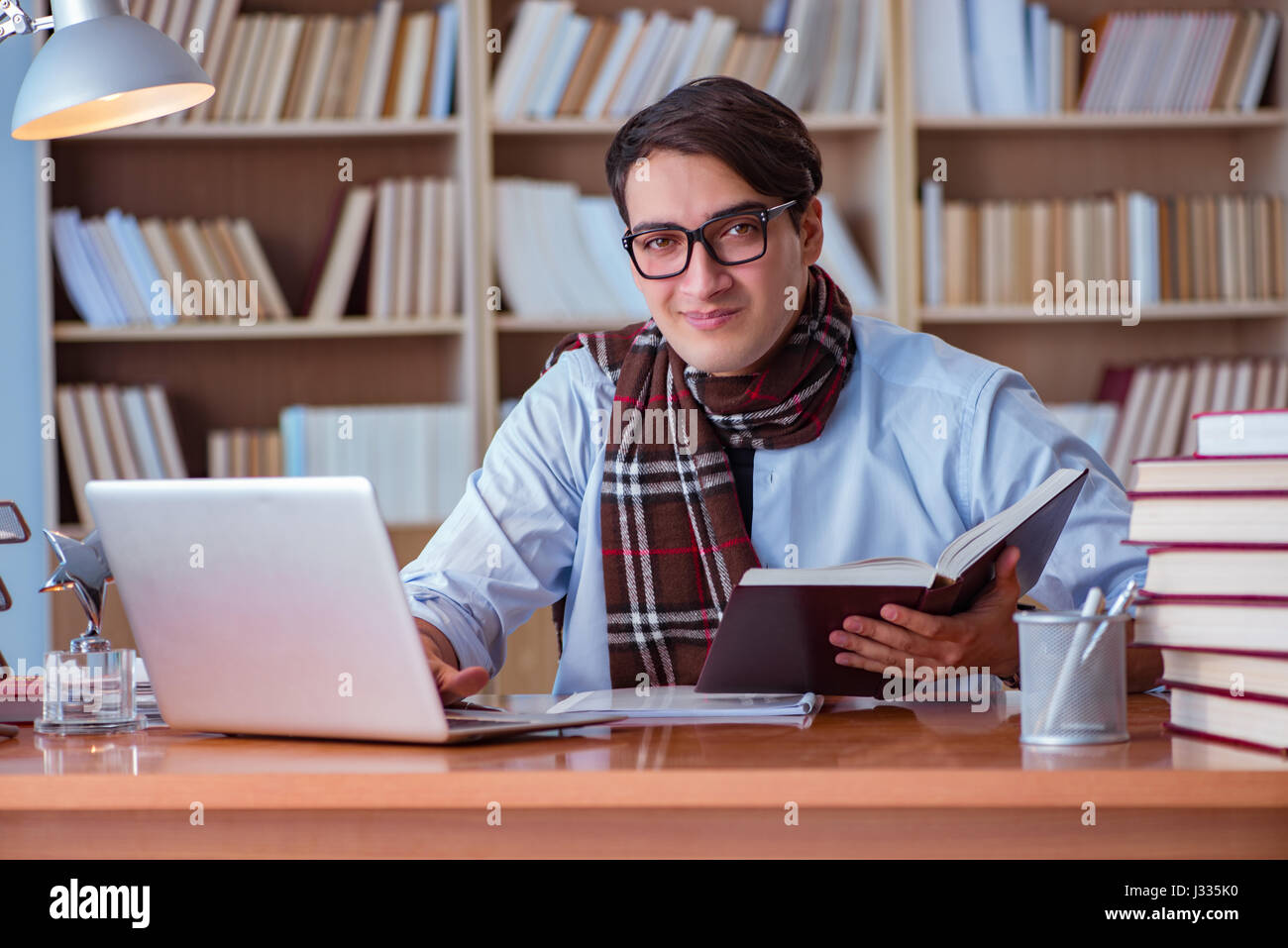 Young book writer writing in library Stock Photo - Alamy