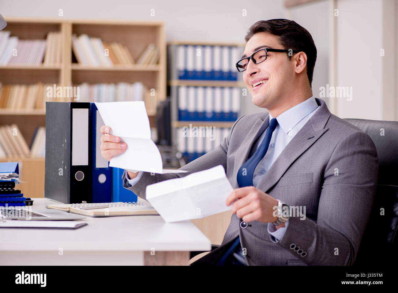 Businessman receiving letter envelope in office Stock Photo - Alamy