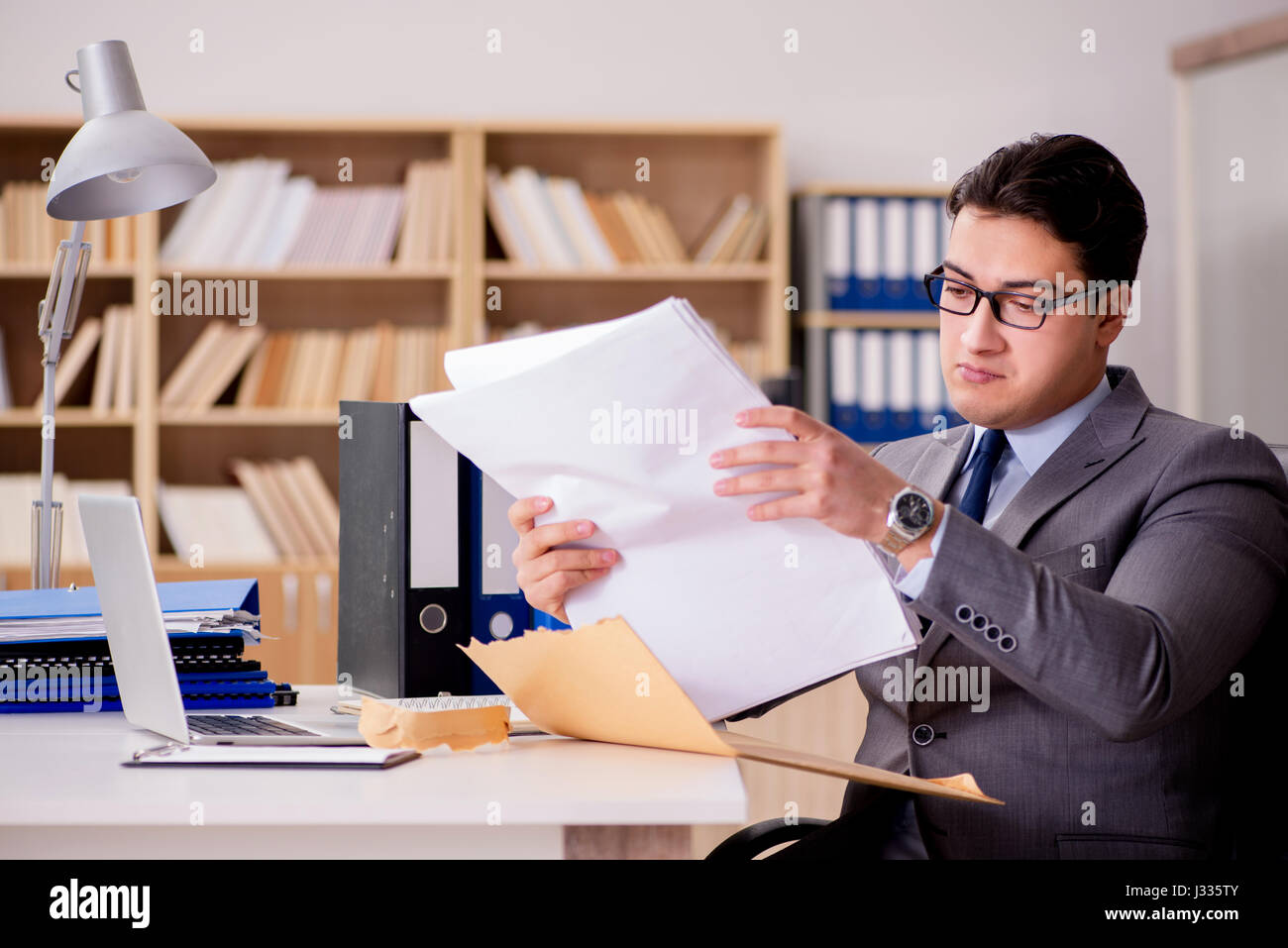 Businessman receiving letter envelope in office Stock Photo - Alamy