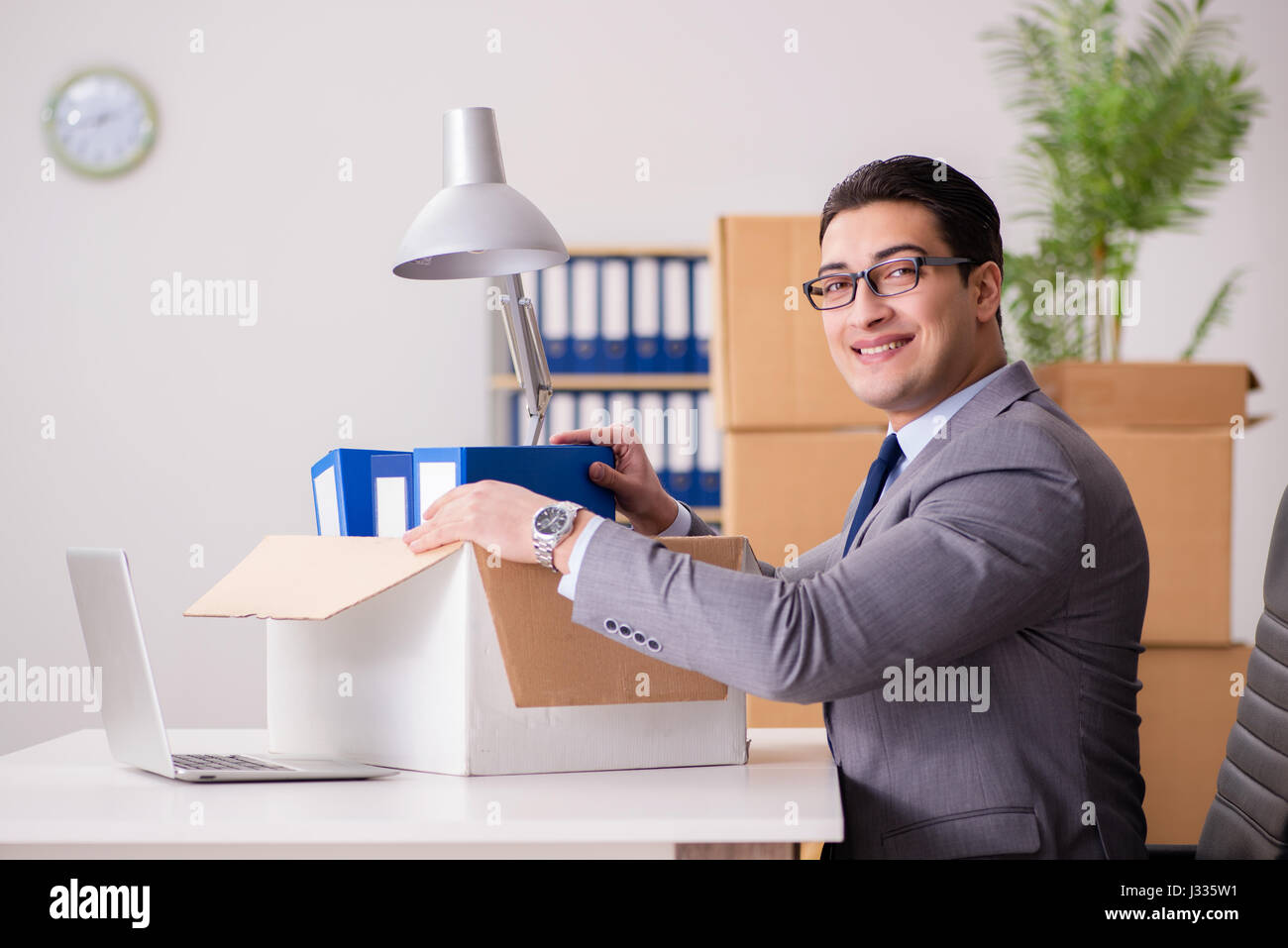 Young handsome businessman moving offices Stock Photo - Alamy