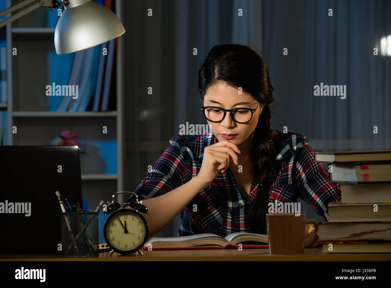Young woman doing homework at night. Tired hispanic girl and college ...